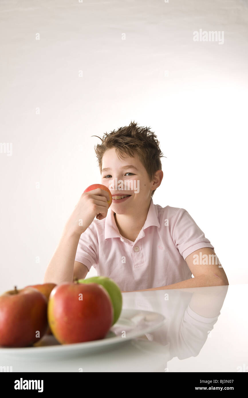 A boy holding an apple in his hand, smiling Stock Photo - Alamy