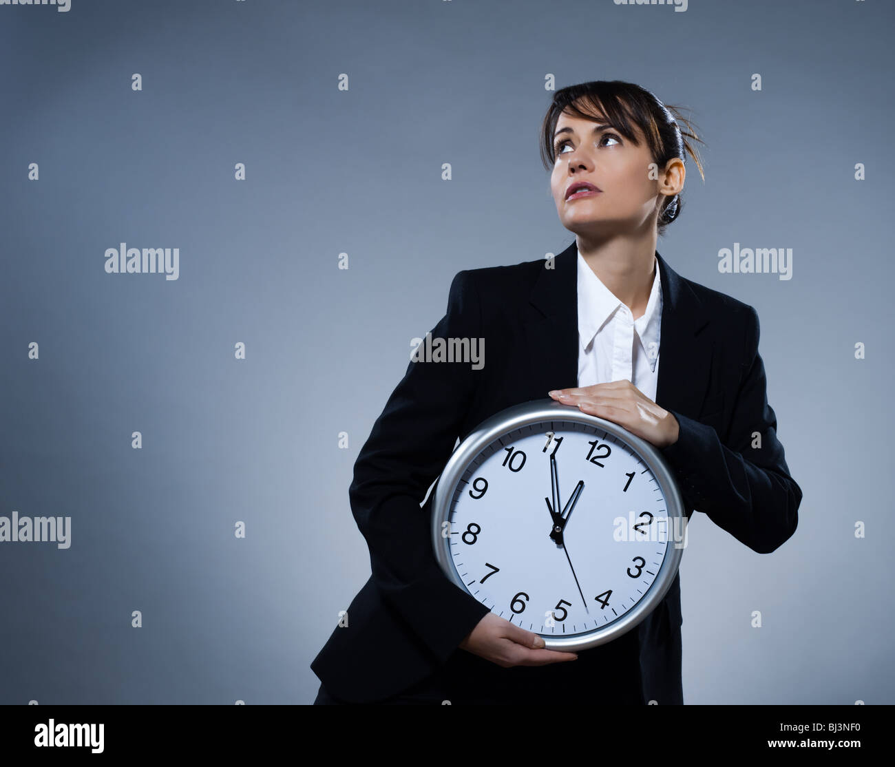 beautiful woman on isolated backgound holding a clock Stock Photo - Alamy