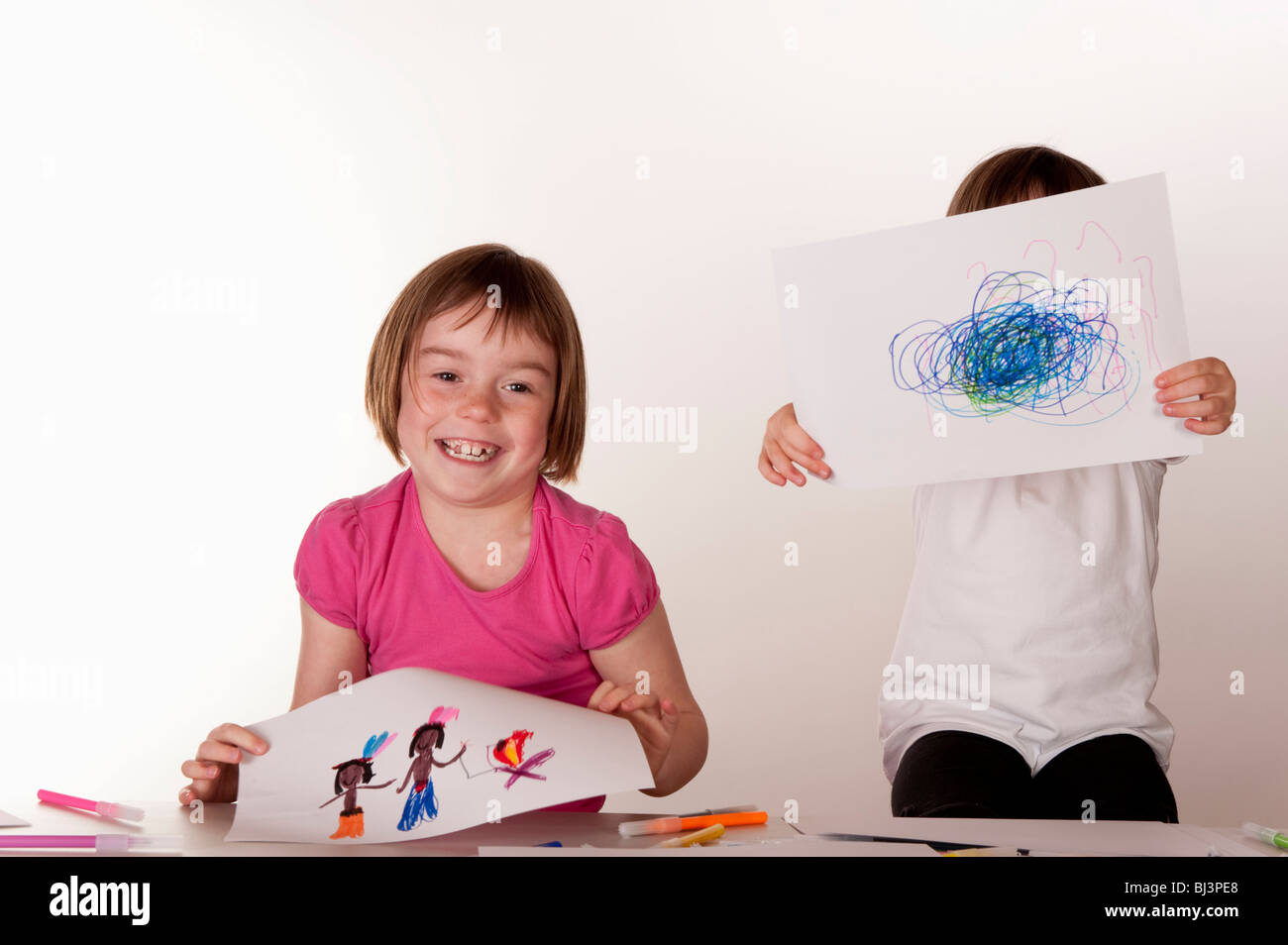 two little girls enjoying coloring and drawing pictures art Stock Photo ...