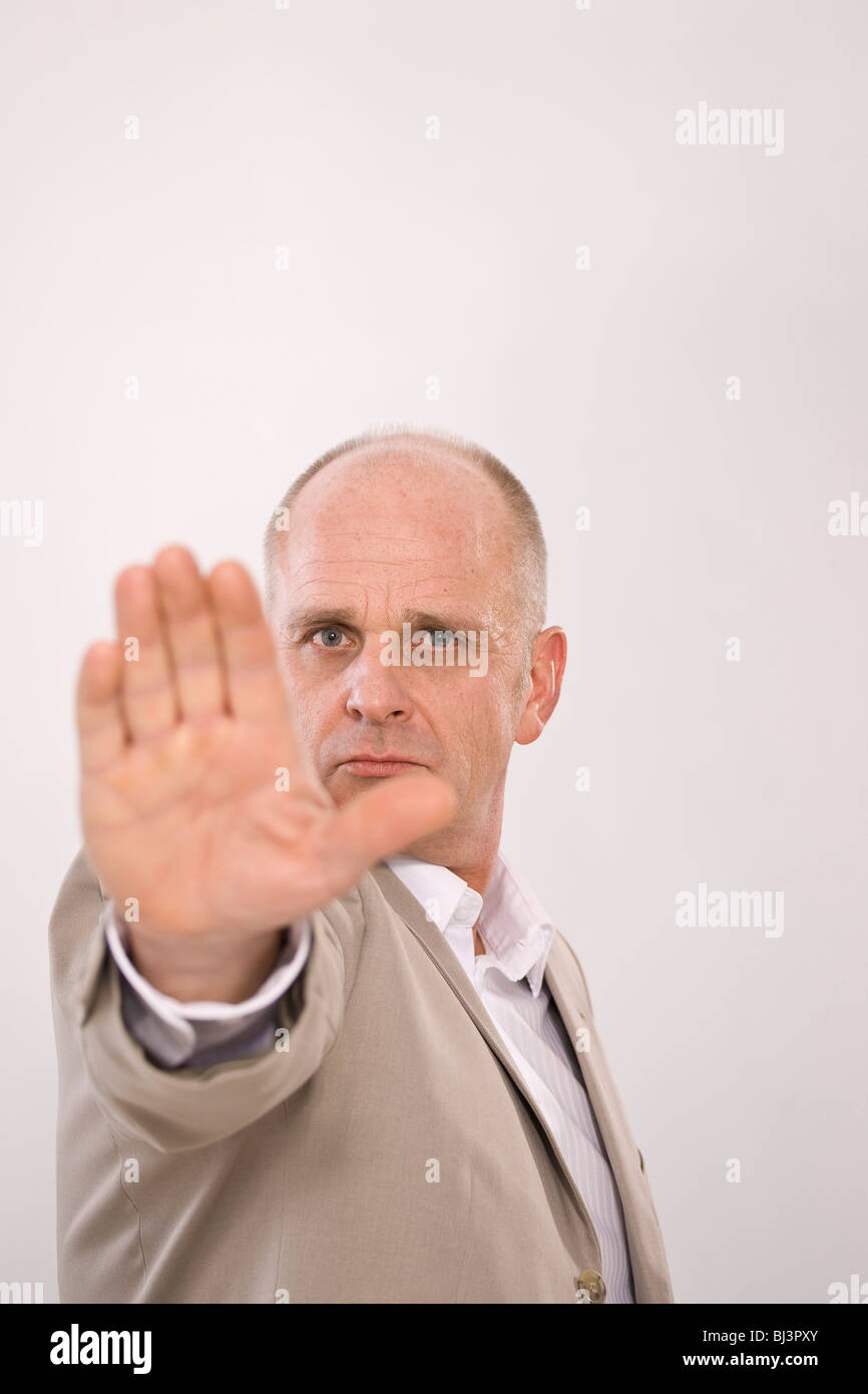 Man thrusting his hand forward in defense Stock Photo - Alamy