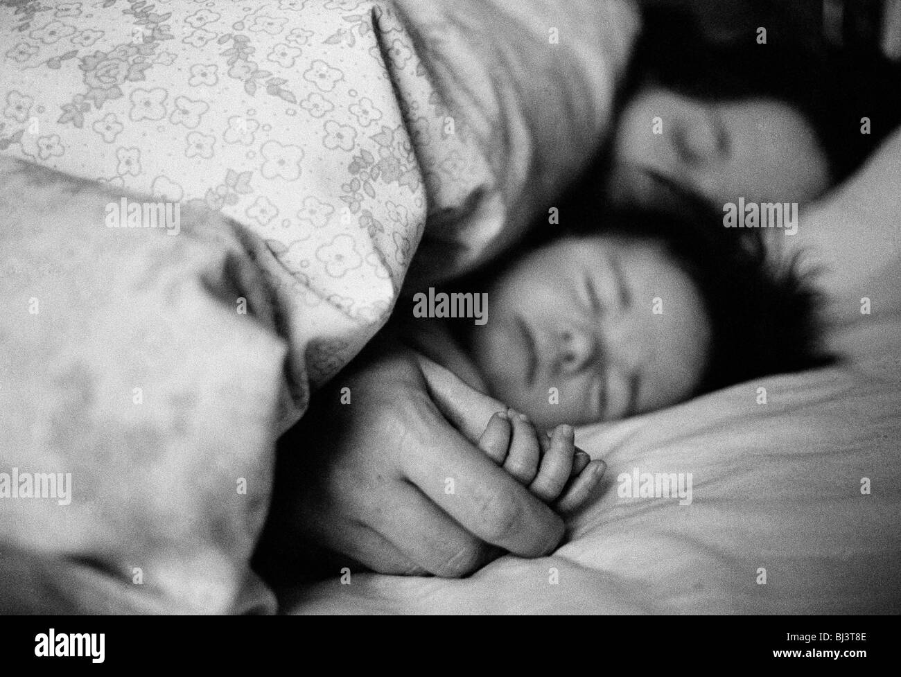 A mother has brought her three and a half month-old infant into bed and ...