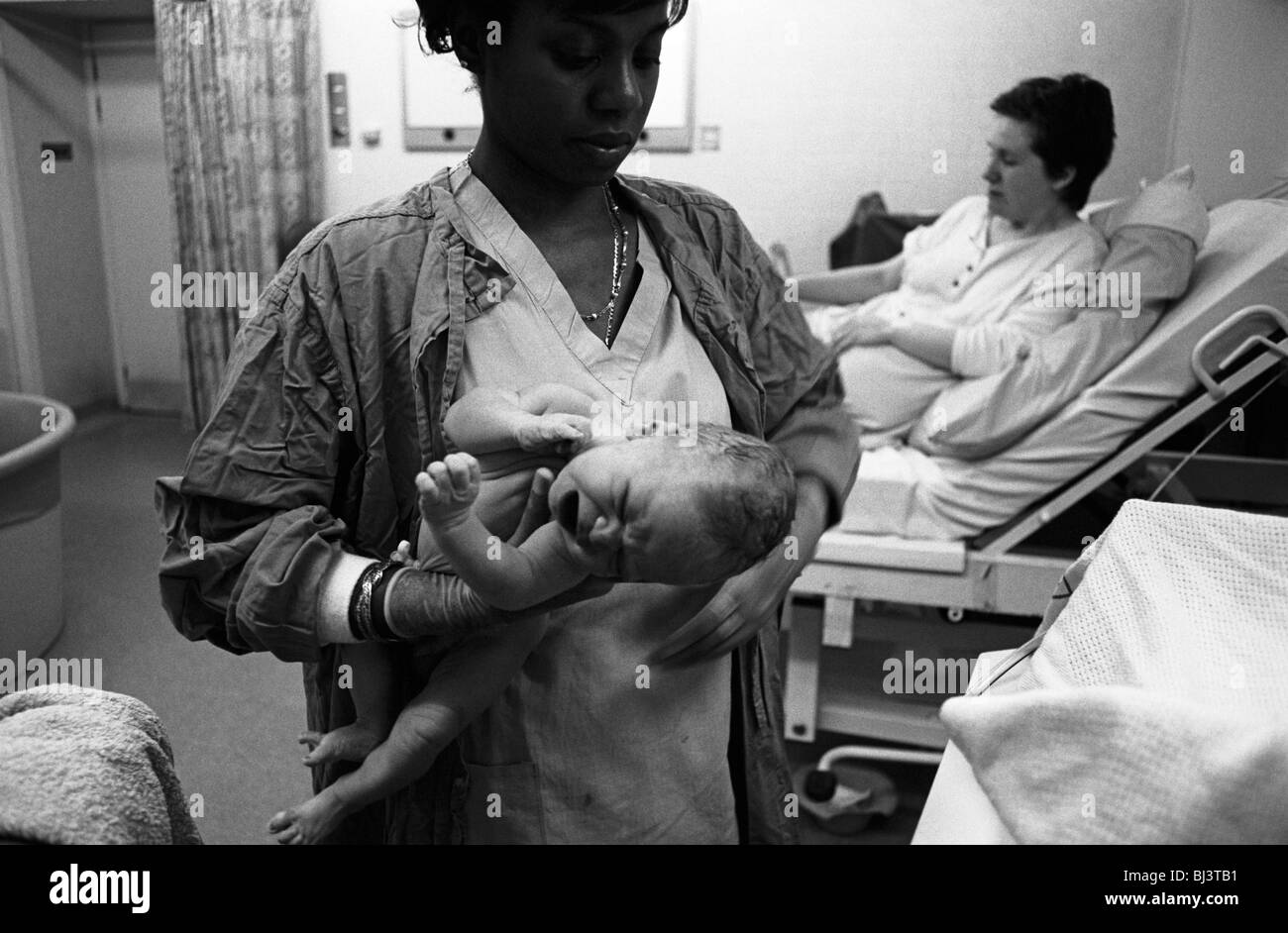 A newborn baby boy is carried away from his mother immediately after ...