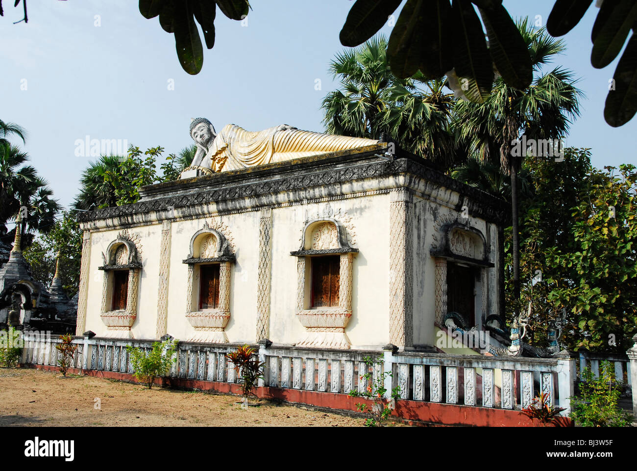 lying buddha made of stone lying on top of temple, baan guluang village ...