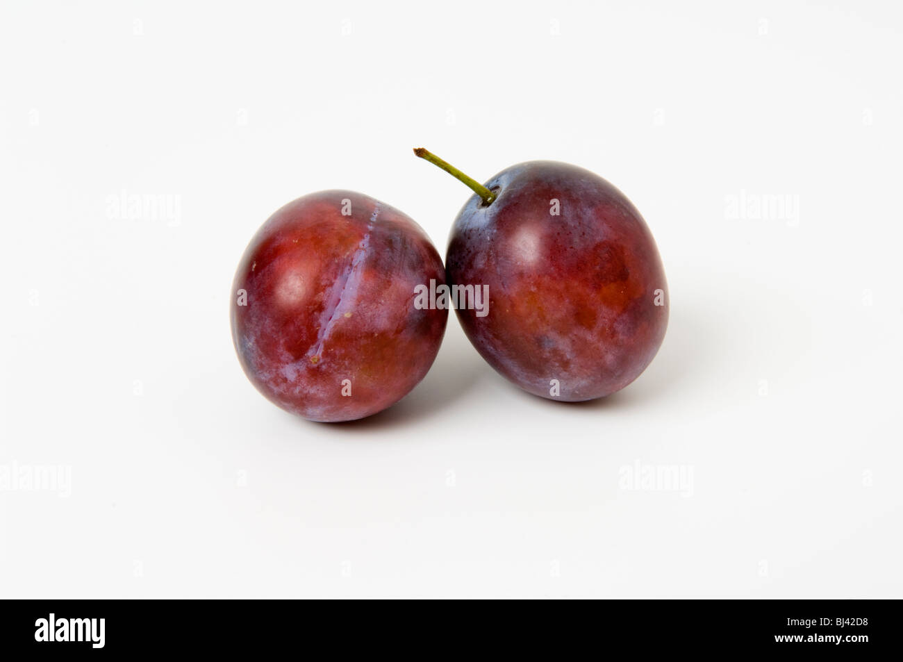 Pair of plums side by side Stock Photo - Alamy