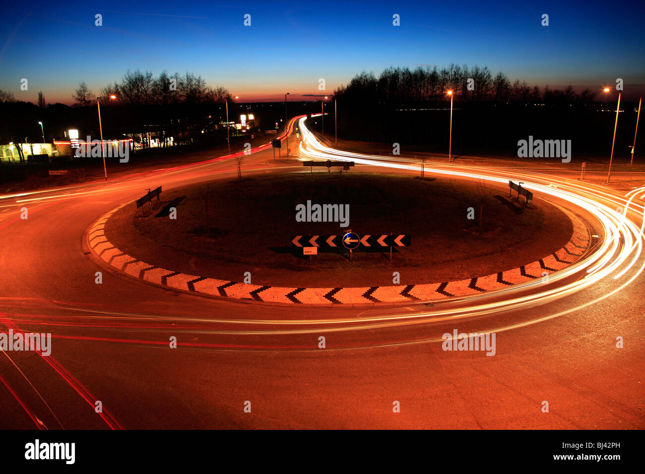 Cars and traffic light trails on a roundabout Stock Photo - Alamy