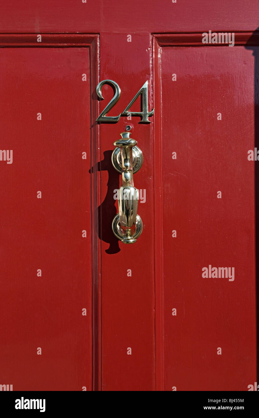 door knocker on red wooden door with number 24 on Stock Photo - Alamy