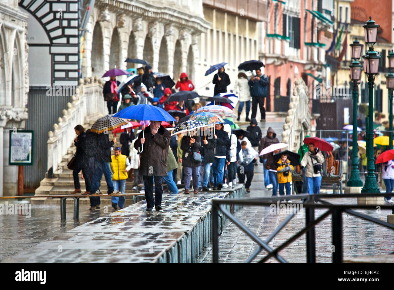 People walking along raised walkways during High Water, Acqua Alta, in ...