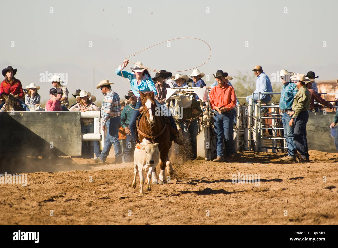 a cowgirl competes in the breakaway roping event during a high shcool ...