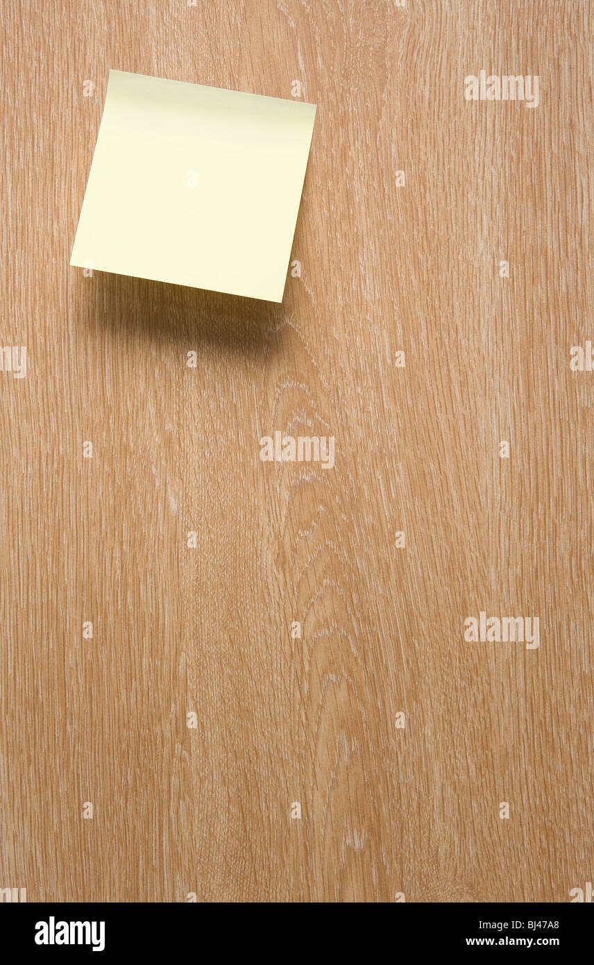 A Blank Yellow Post It Note on a Wooden Door Stock Photo - Alamy