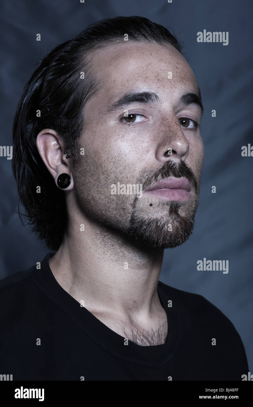 urban stylish caucasian young man with pierced ears and piercing studio ...