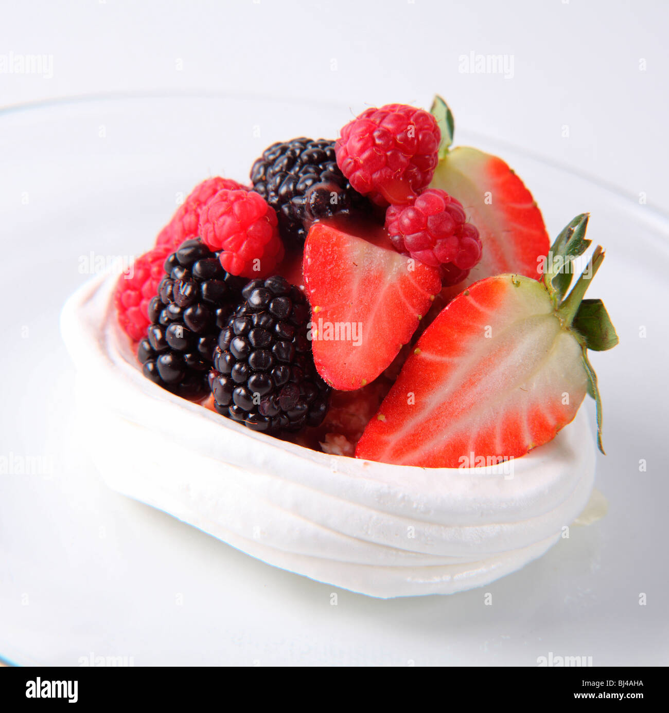 Pavlova; Meringue Nest with Fruits of the Forest Stock Photo - Alamy