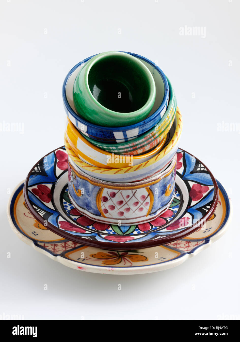 Colourful painted crockery Stock Photo - Alamy