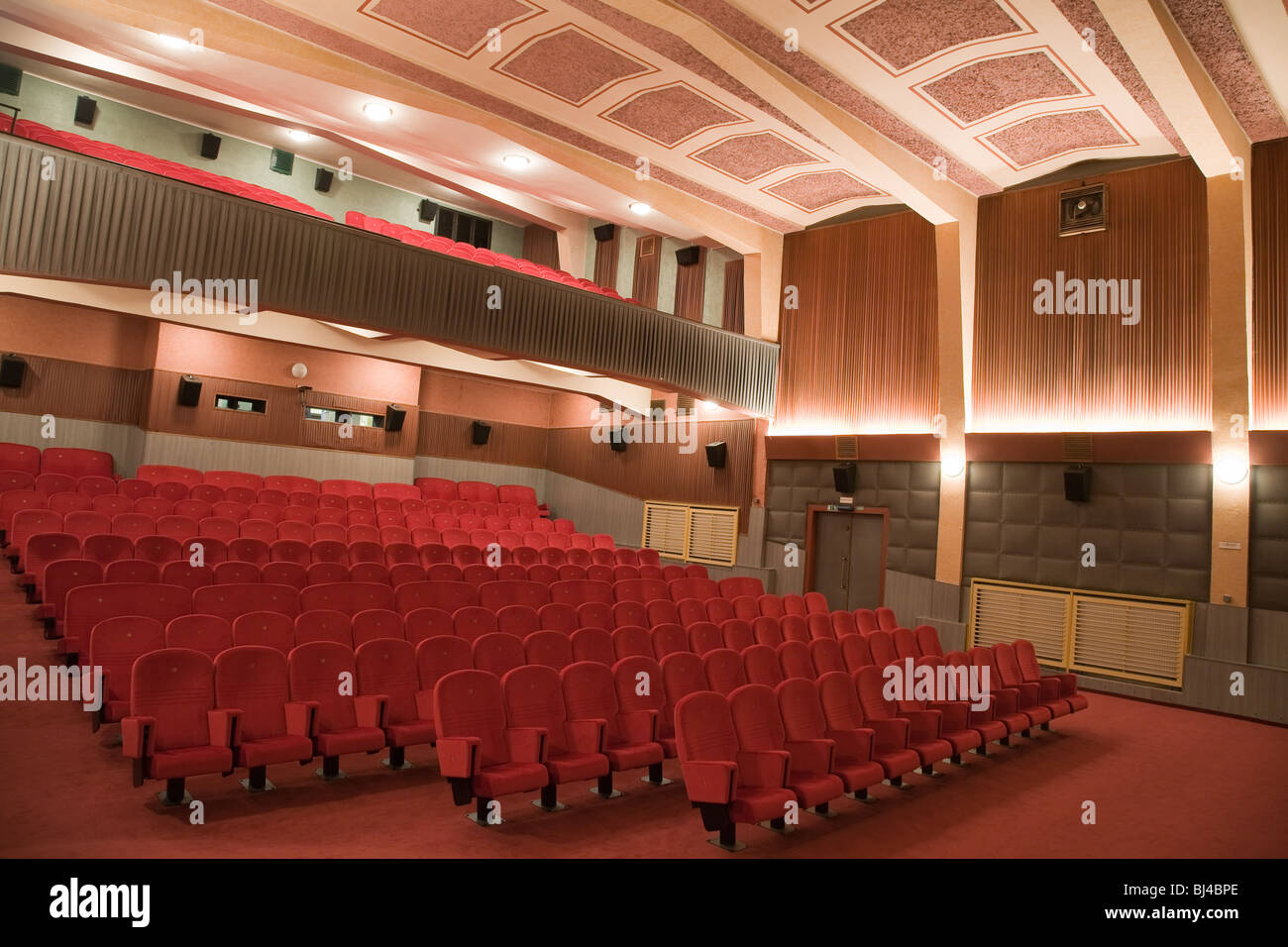 Interior of retro cinema auditorium with balcony in cubism style with ...
