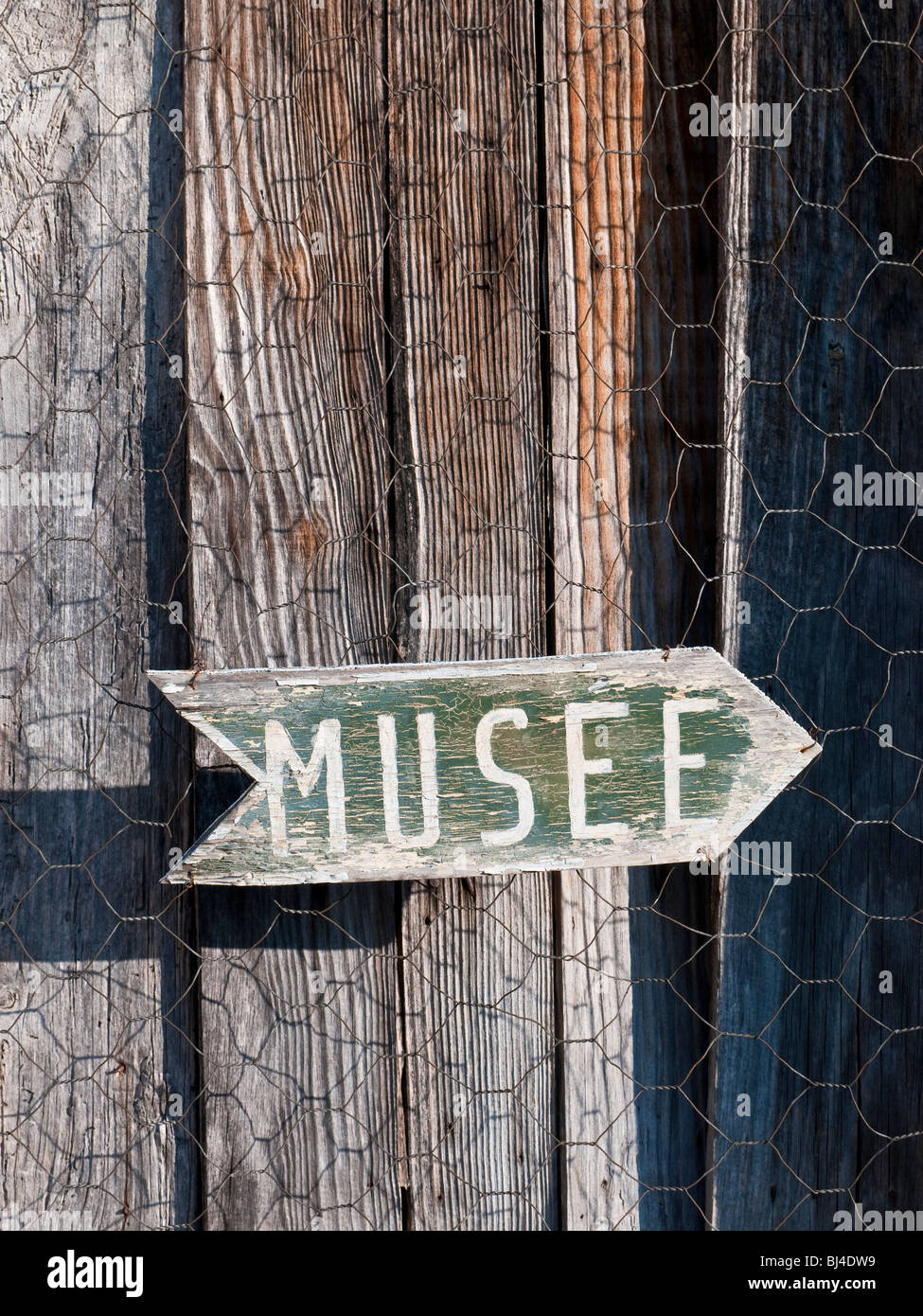 Old hand-painted direction sign for town museum - France Stock Photo ...