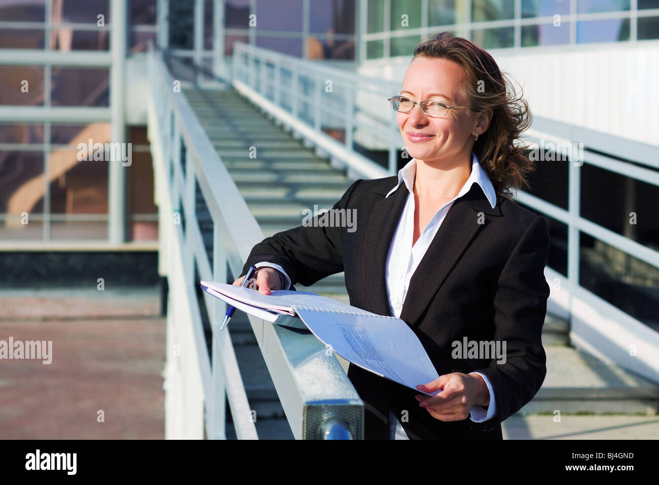 Happy businesswoman on the stairway of airport terminal Stock Photo - Alamy