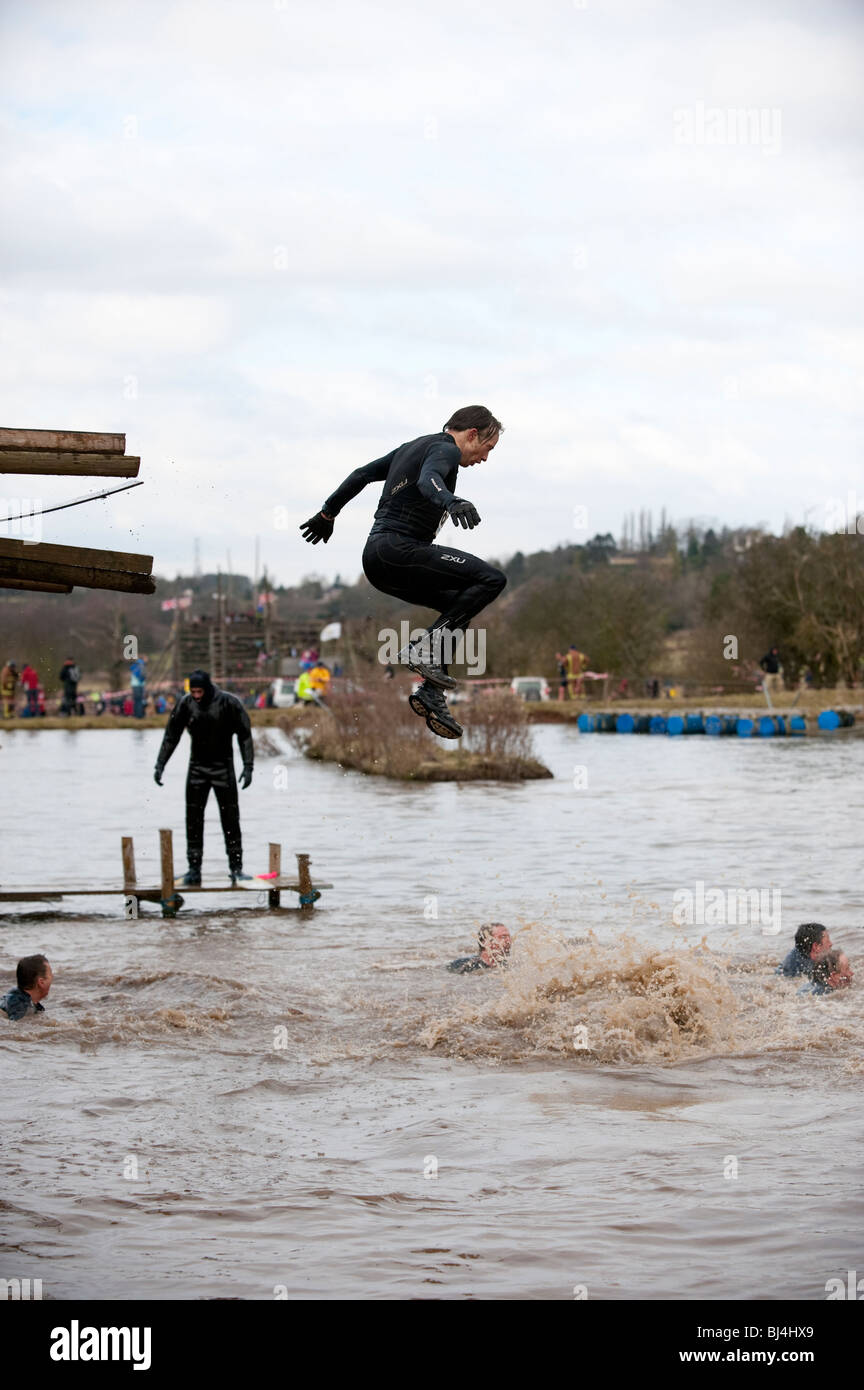 Man jumping into cold muddy water from height Stock Photo - Alamy