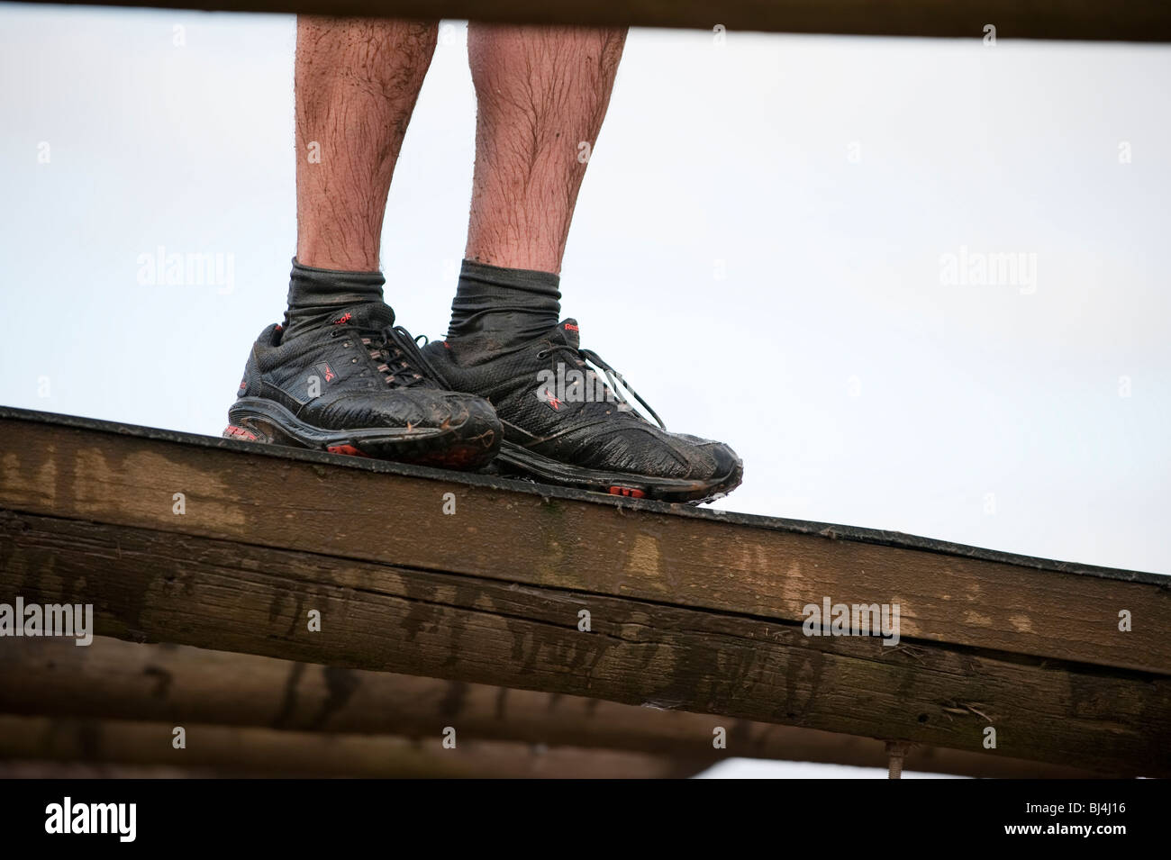 Wet cold muddy cross country runner feet Stock Photo - Alamy