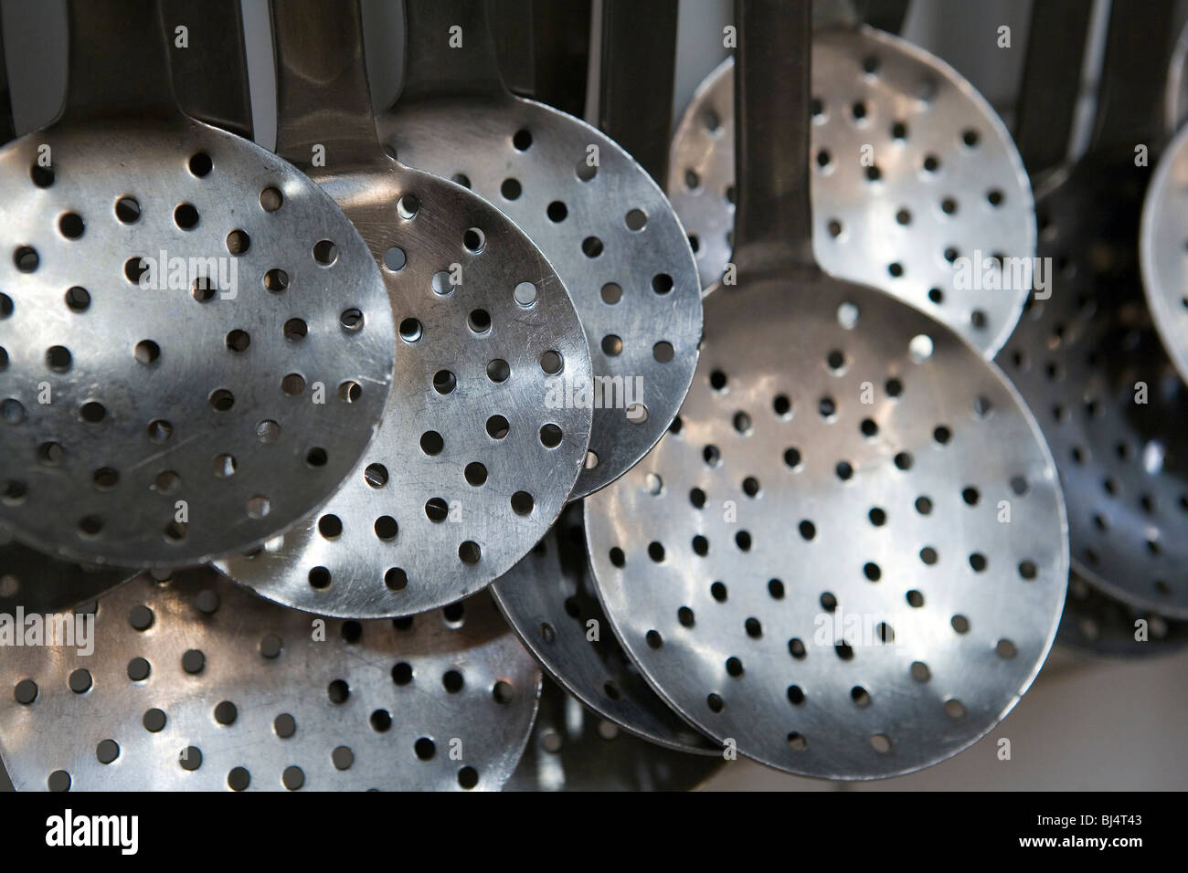 Skimming ladles in a commercial kitchen Stock Photo - Alamy