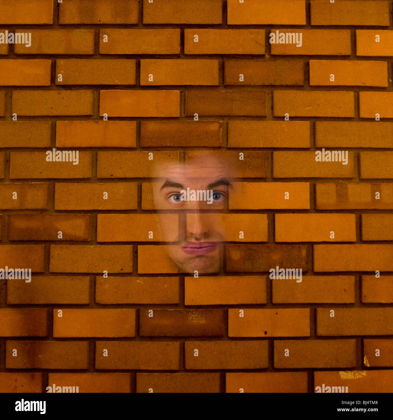 Face in a brick wall Stock Photo - Alamy