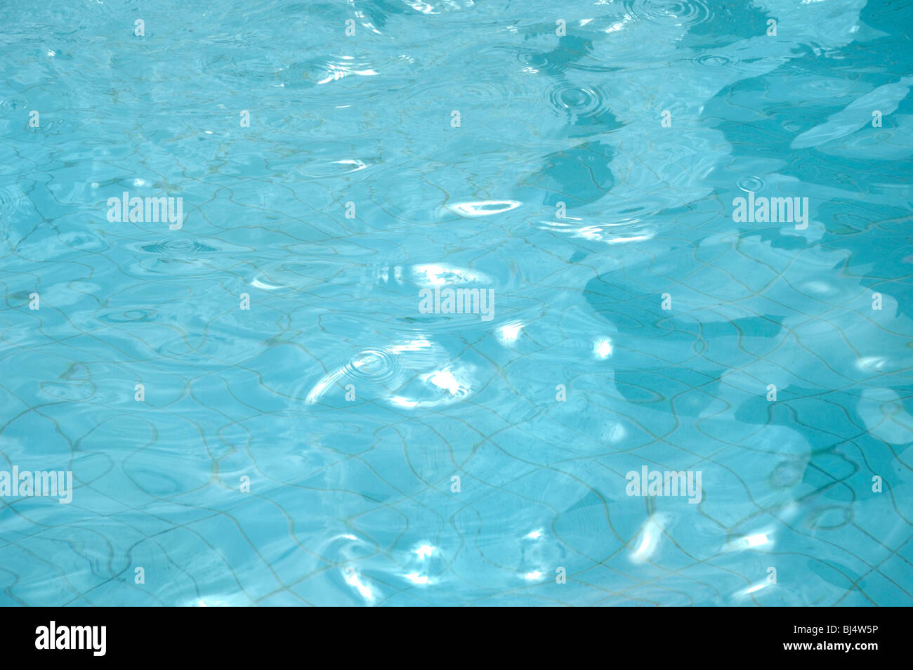 Swimming pool with blue tiled bottom abstract water texture background ...