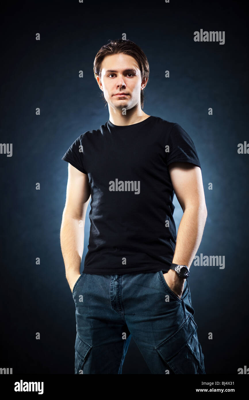 Young man. On dark blue background Stock Photo - Alamy