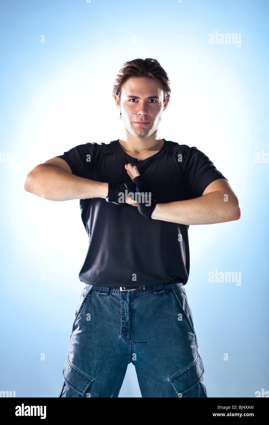 Strong man ready to fight. On soft blue background Stock Photo - Alamy