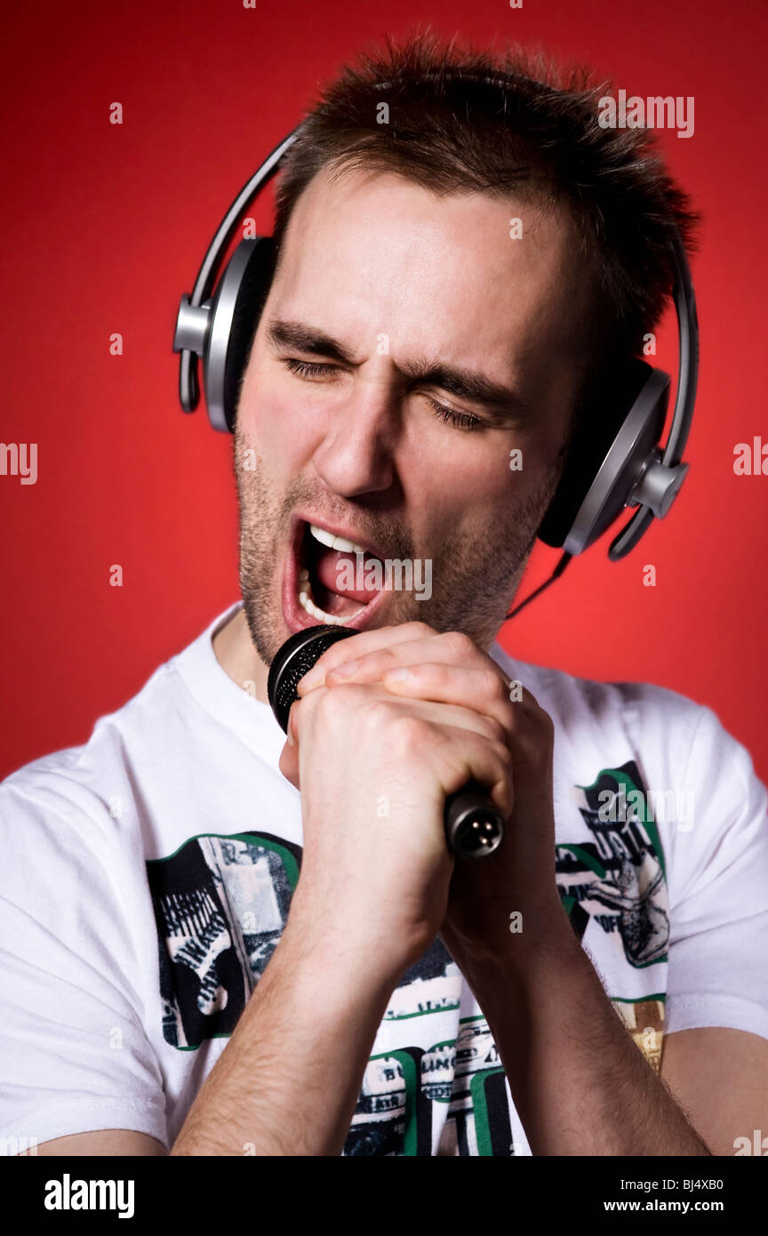 singing young man wearing headphones Stock Photo - Alamy