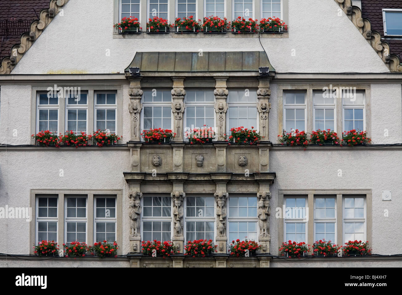 Front of the very traditional Hirmer Building with red flowerpots on ...