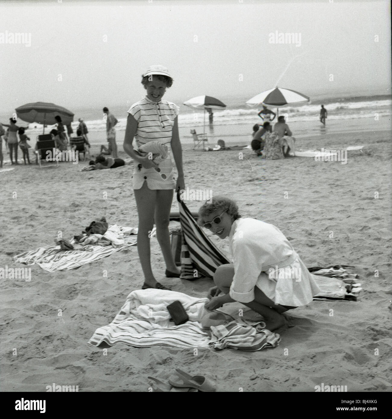 Fashionable woman at the beach during the 1950s. smiling happy sun ...