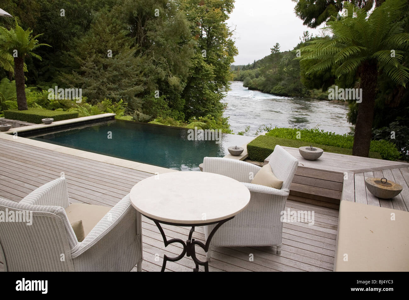 An infinity pool and deck overlook the Waikato River at Huka Lodge ...