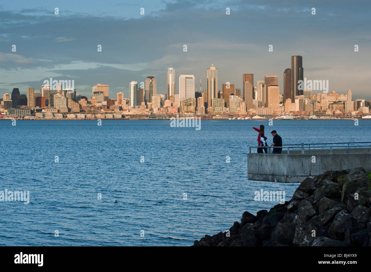 At an Alki Beach park, visitors enjoy the sunset over Elliott Bay and ...