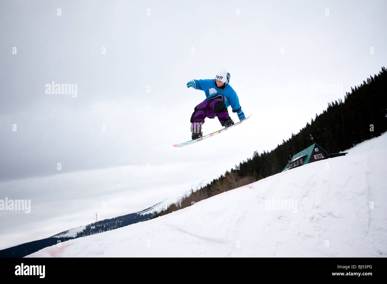 Person jumping in mid-air on snowboard Stock Photo - Alamy