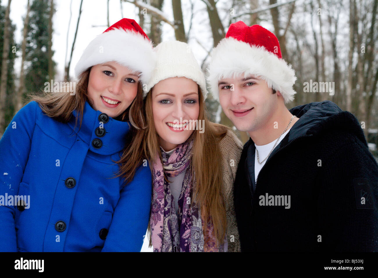 Three friends having a christmas walk Stock Photo - Alamy