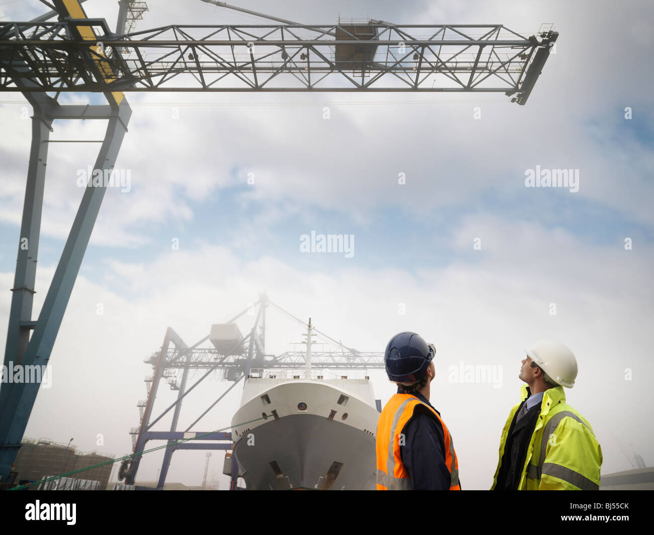 Port Worker And Businessman With Ship Stock Photo - Alamy