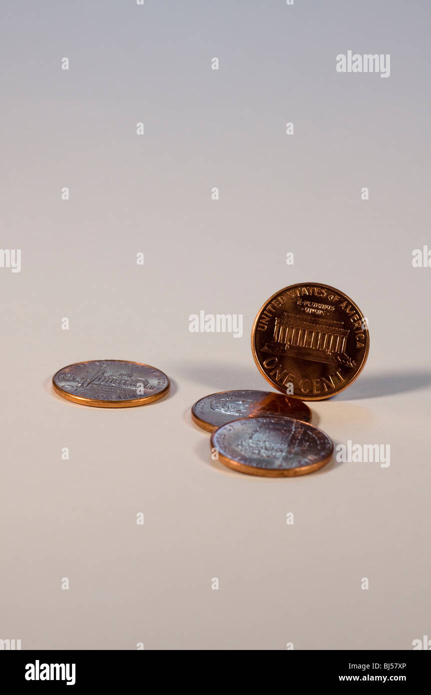 Four one cent coins on white background Stock Photo - Alamy