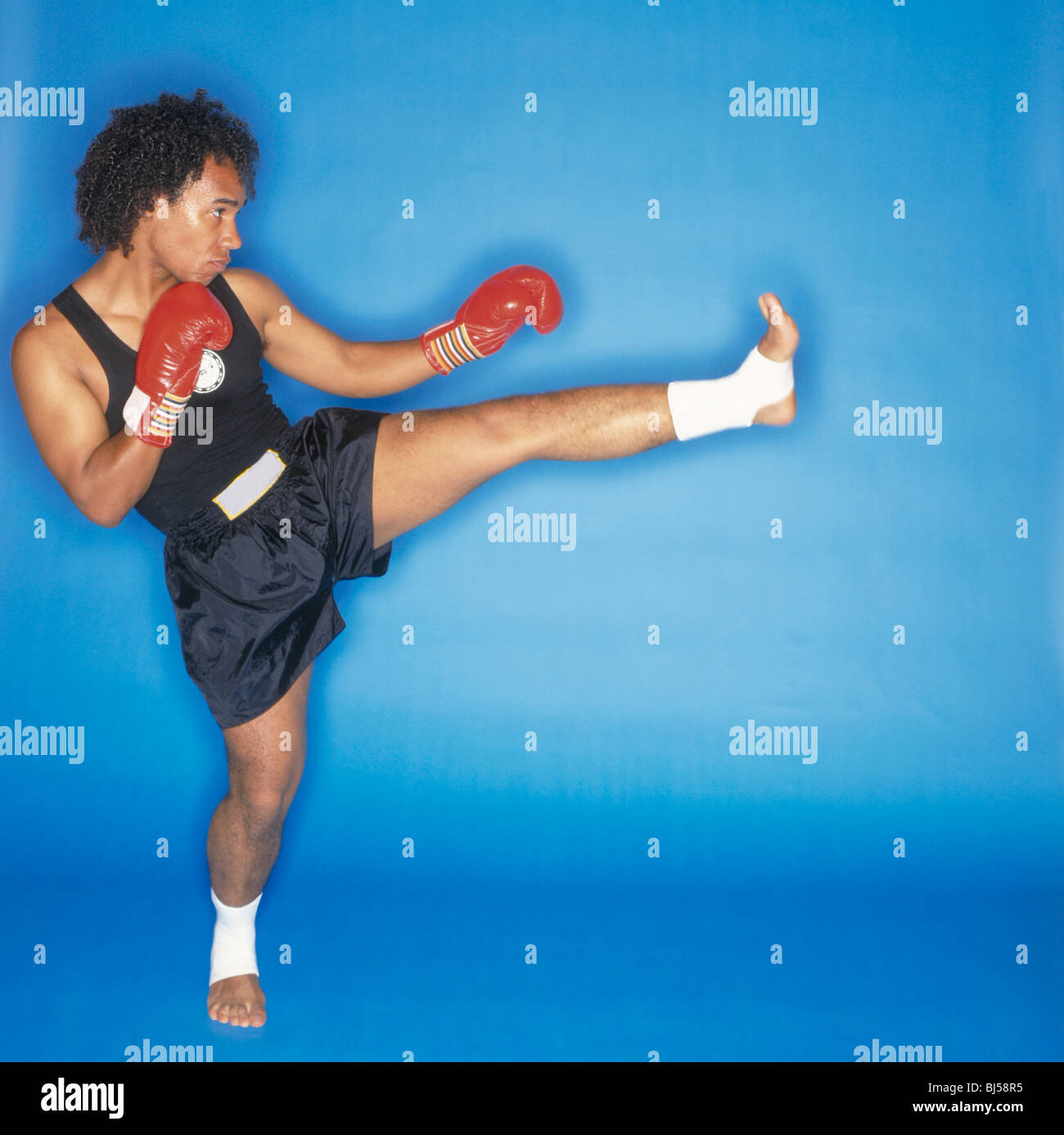 man doing front kick, side view Stock Photo - Alamy