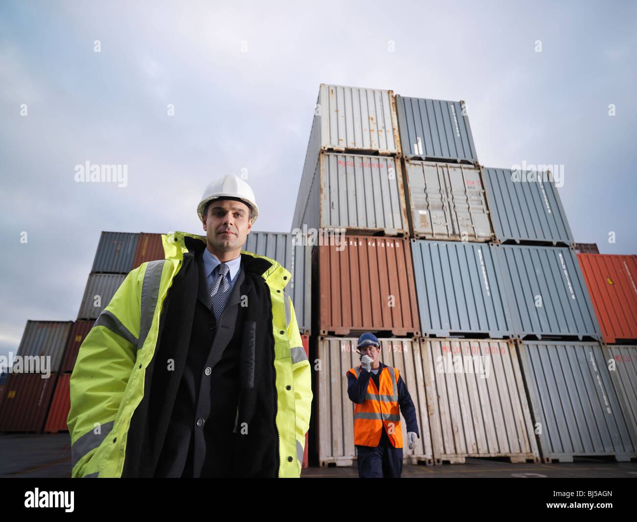 Port Workers With Shipping Containers Stock Photo - Alamy