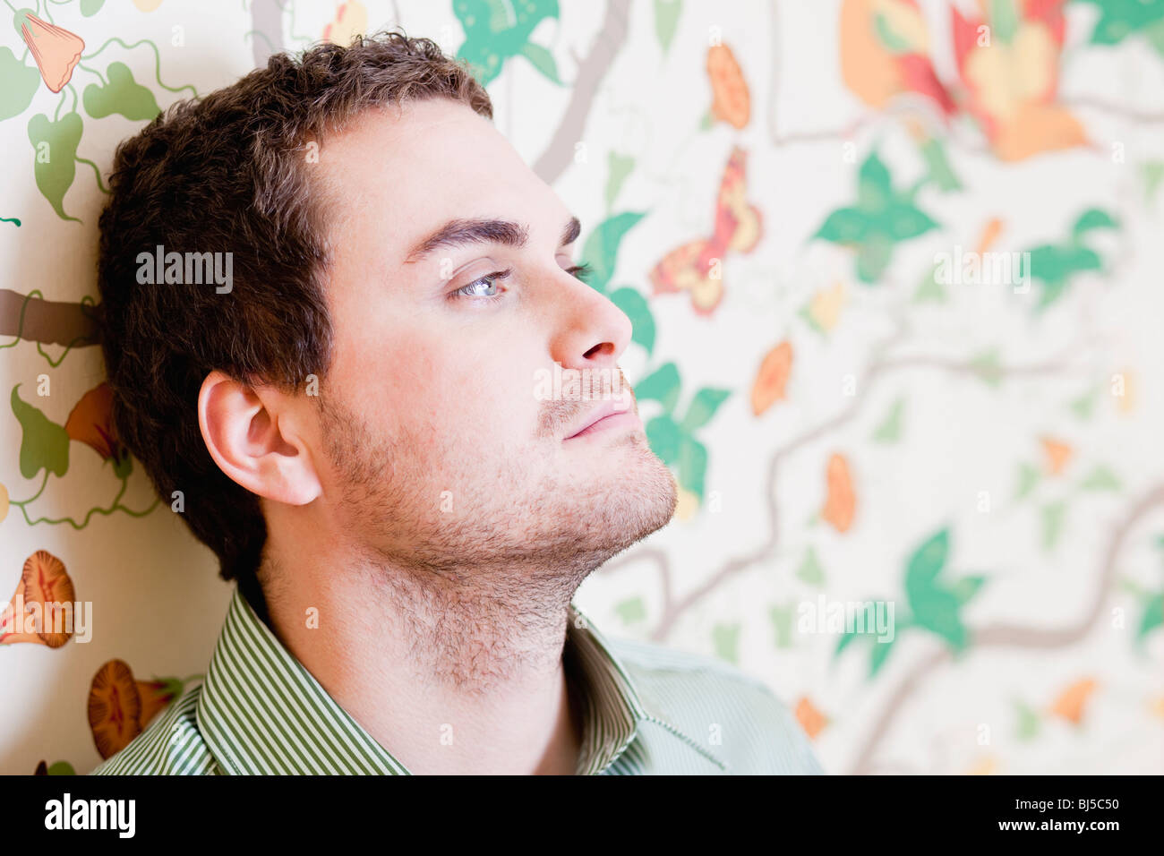man leaning back of head against wall Stock Photo - Alamy