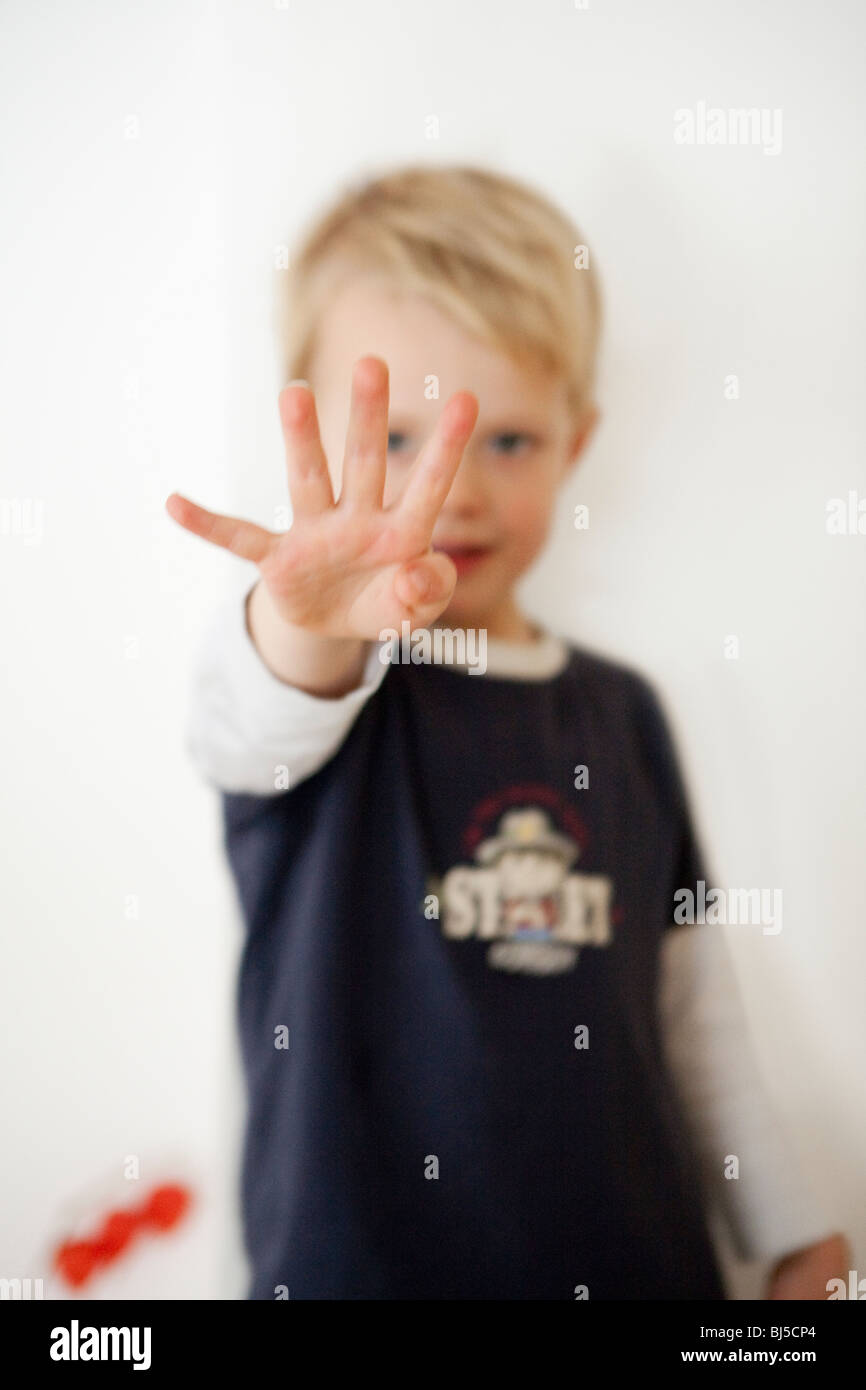 Boy pointing four fingers Stock Photo - Alamy