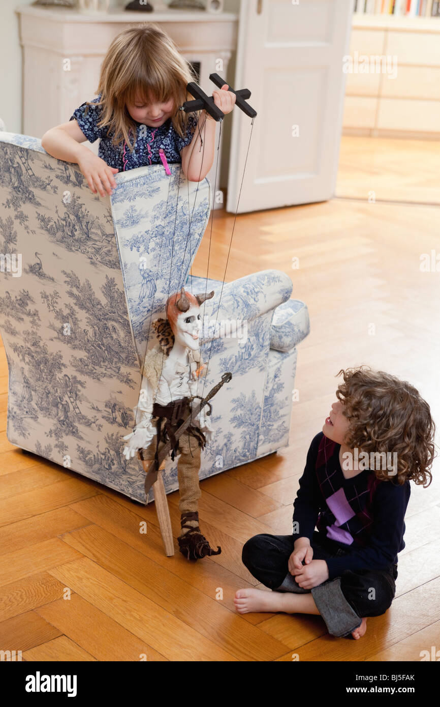 two children playing with puppet Stock Photo - Alamy