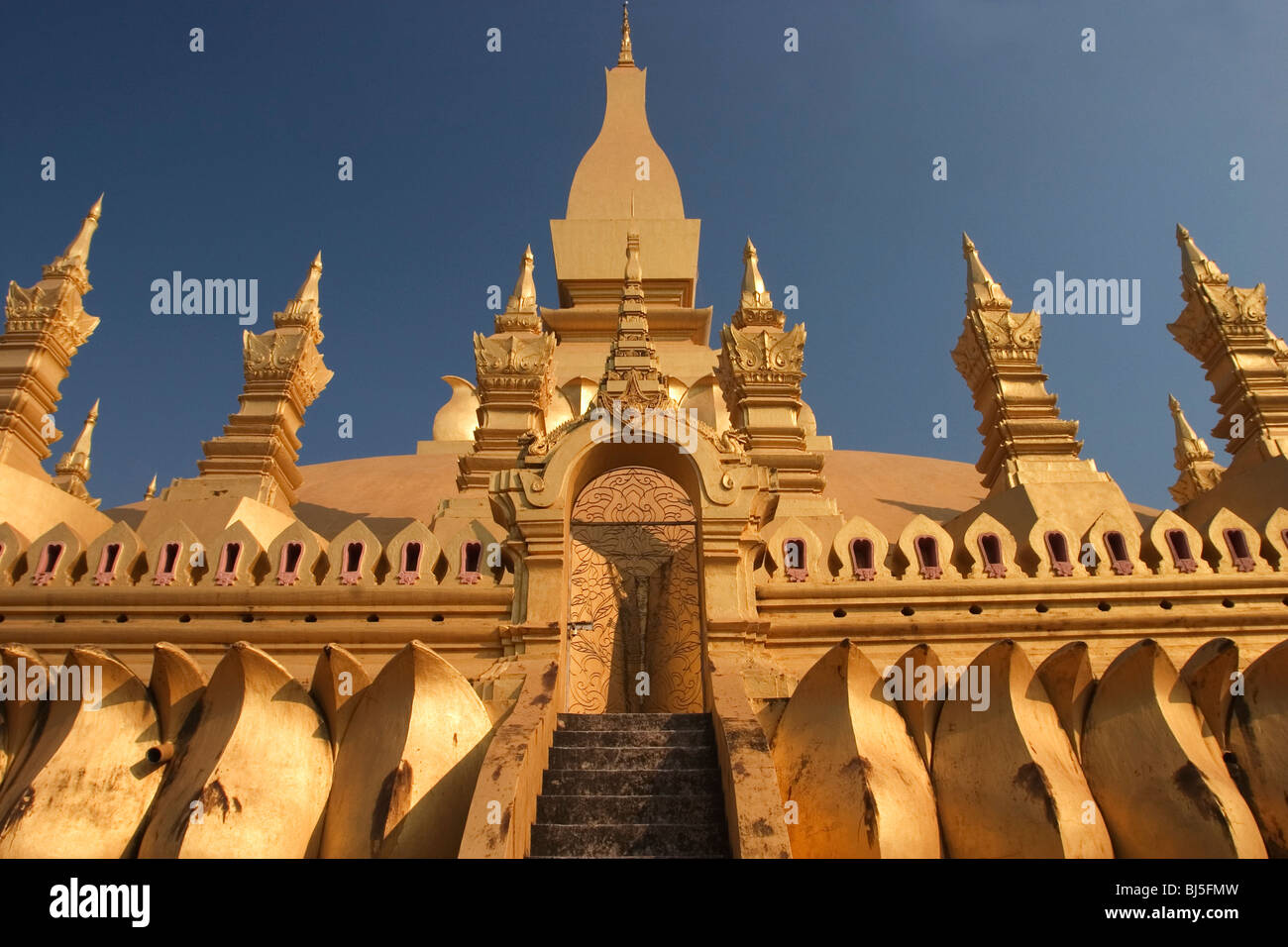 The sun shines on the golden turrets of Pha That Luang pagoda in ...