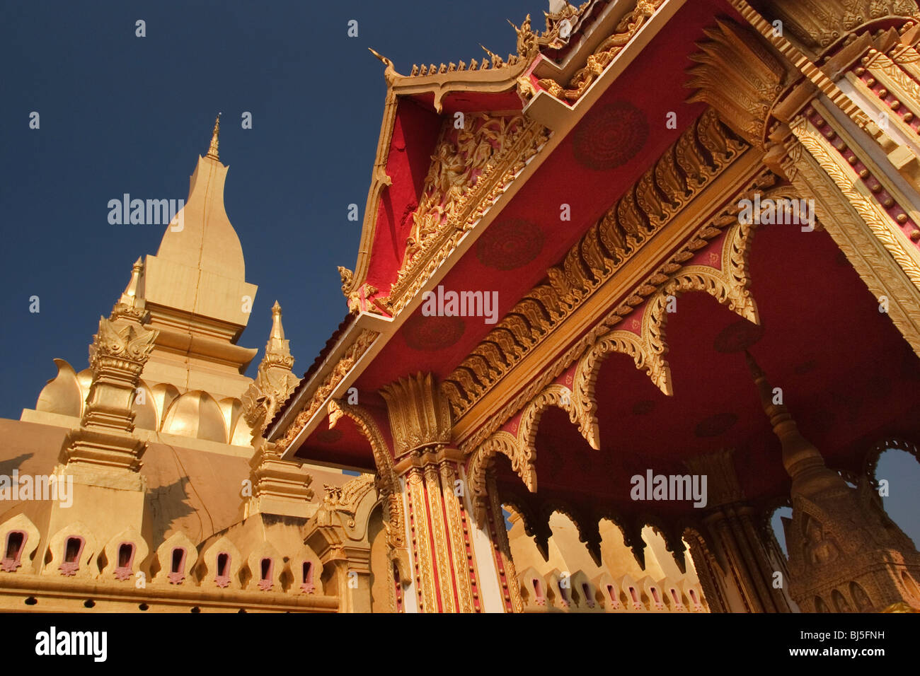 The sun shines on the golden turrets of Pha That Luang pagoda in ...