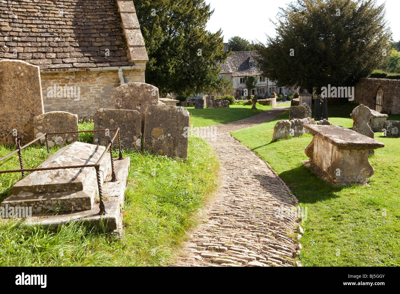 The stone path to St Andrew's in the Cotswold village of Chedworth ...