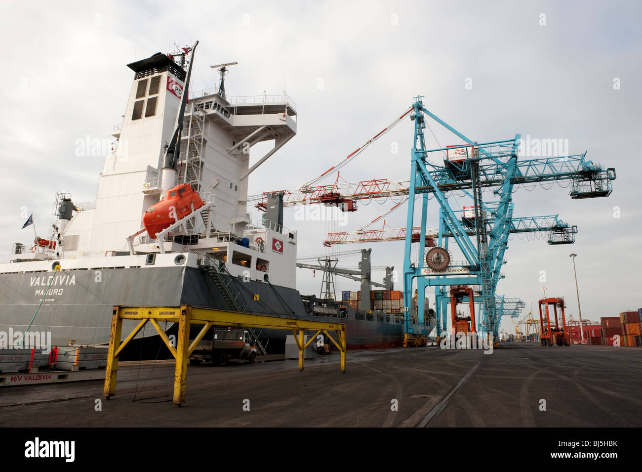 Dockside cranes loading container ship Stock Photo - Alamy