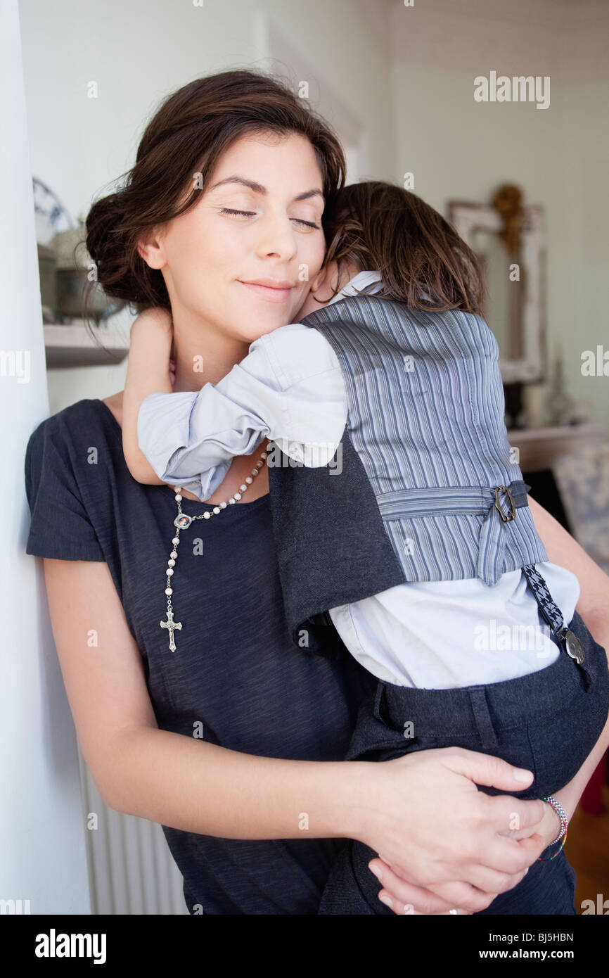 mother holding son in her arms Stock Photo - Alamy