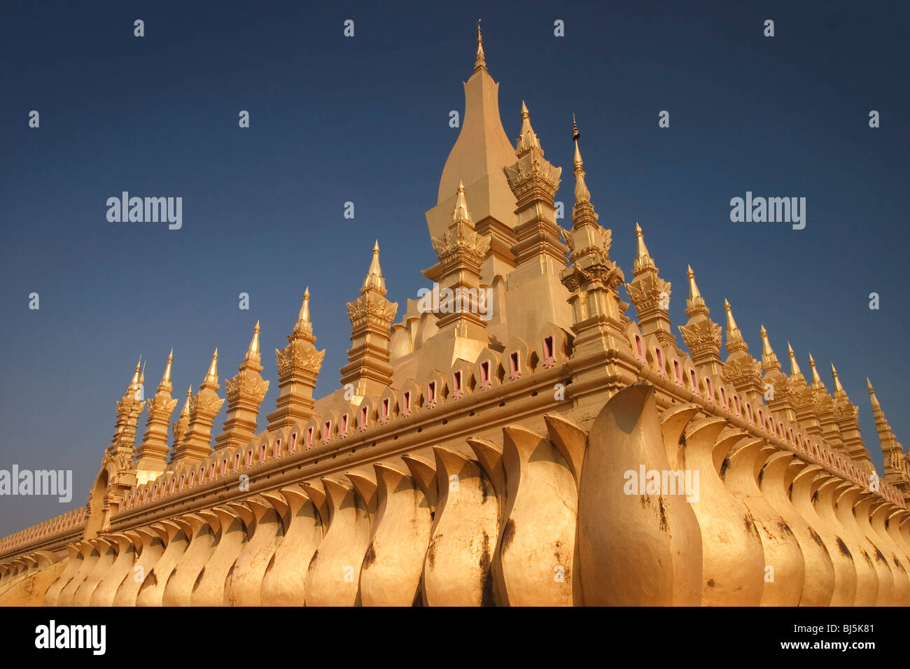 The sun shines on the golden turrets of Pha That Luang pagoda in ...