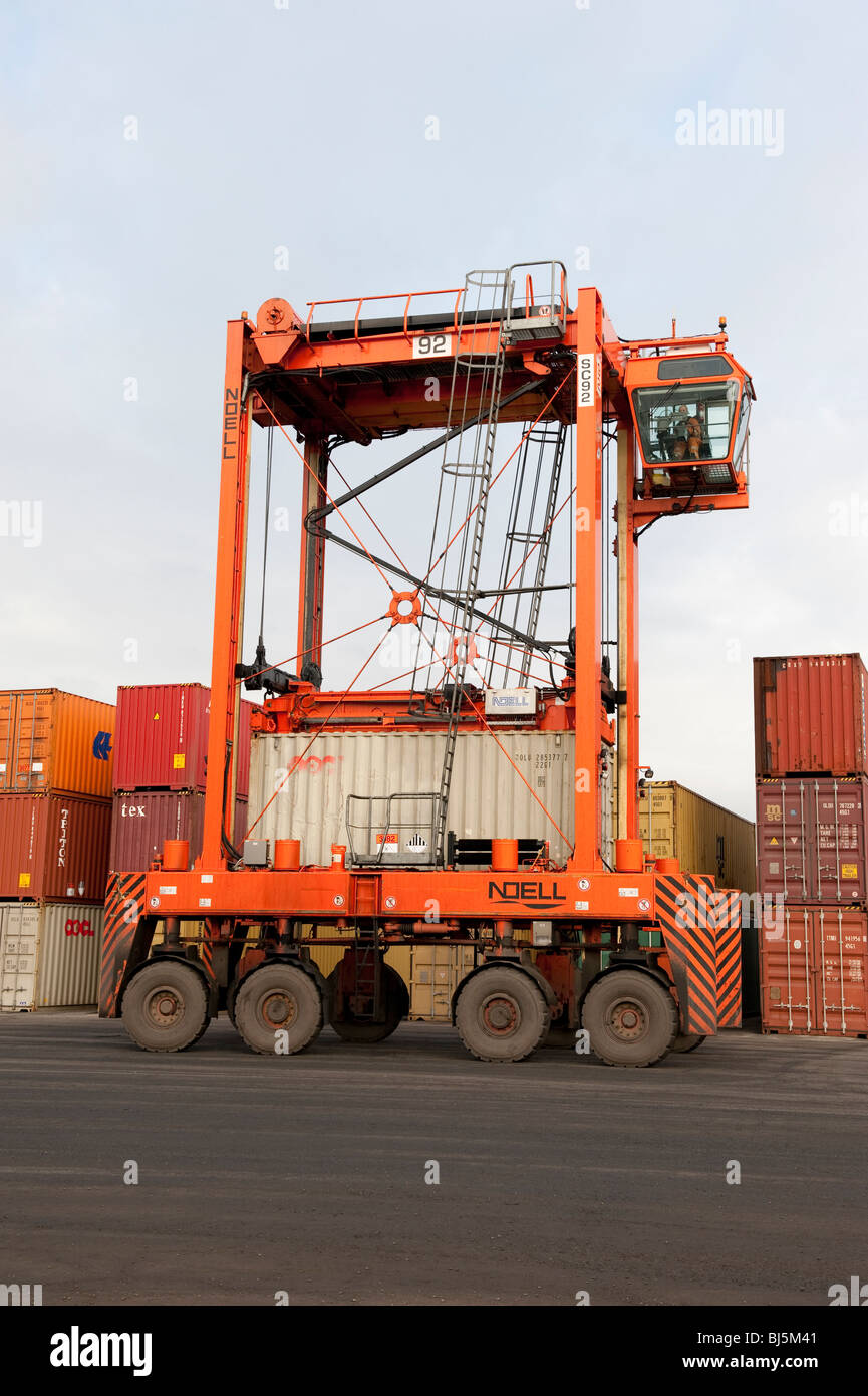 Orange Straddle Carrier crane for lifting ships containers at port ...