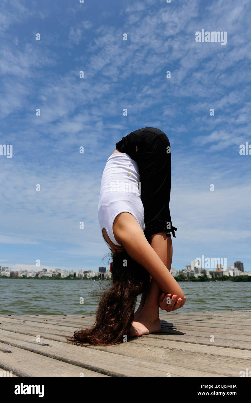 Flexible woman stretching, bending over outdoors Stock Photo - Alamy