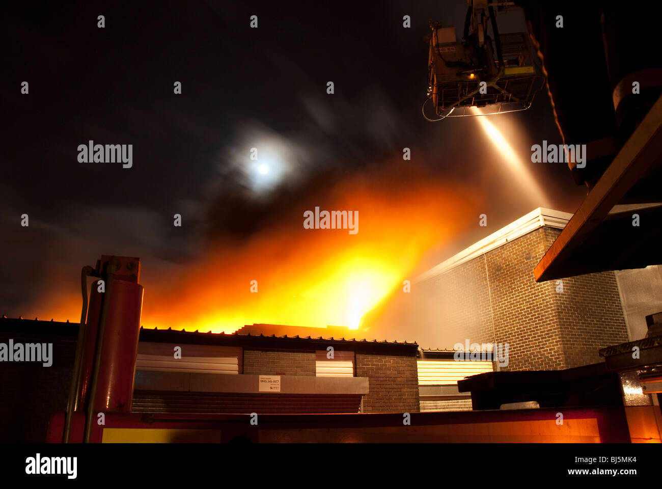 School on fire at night with flames, smoke Stock Photo - Alamy