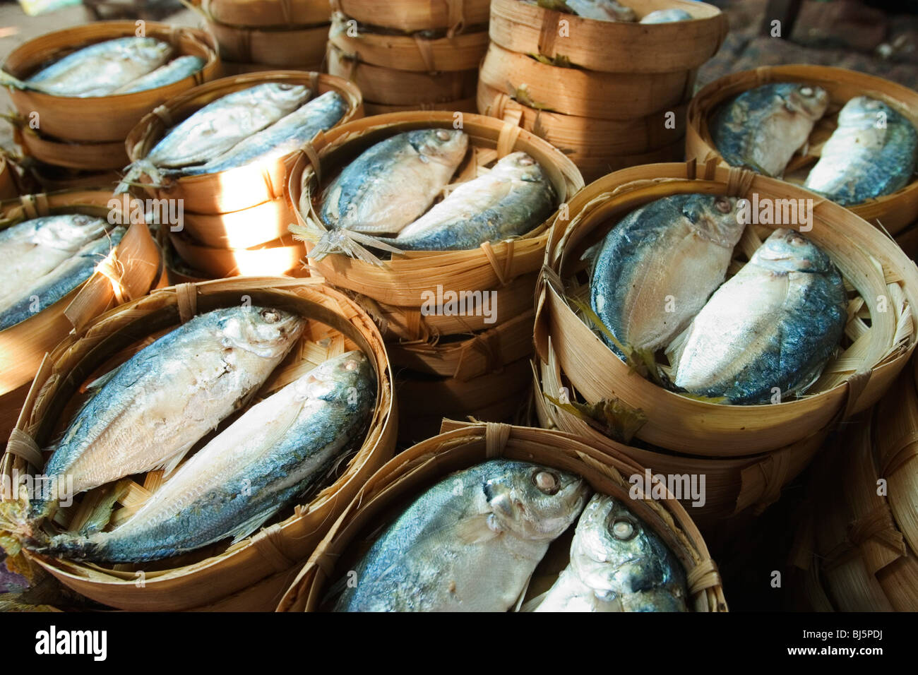 Small fish are sold in rattan baskets at a market in Vientiane, Lao ...